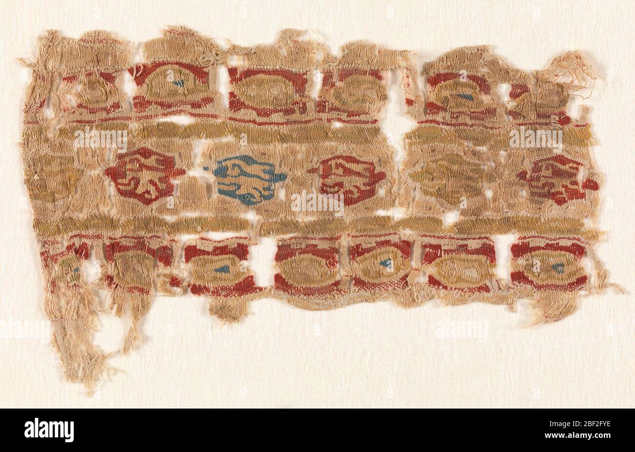 Band fragment. Small fragmentary tapestry band with red guard borders ...