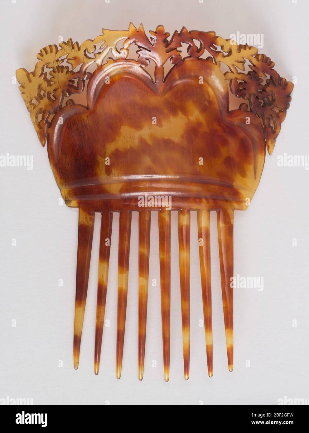 Comb. Tortoiseshell comb with long teeth and stylized folate carving on ...