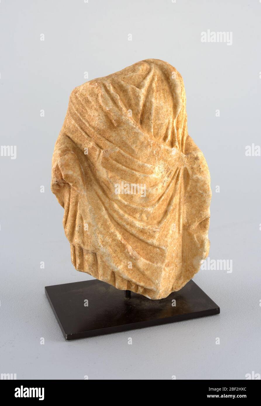 Torso. Fragment of a woman’s torso with pleated robes. Head, hands and ...