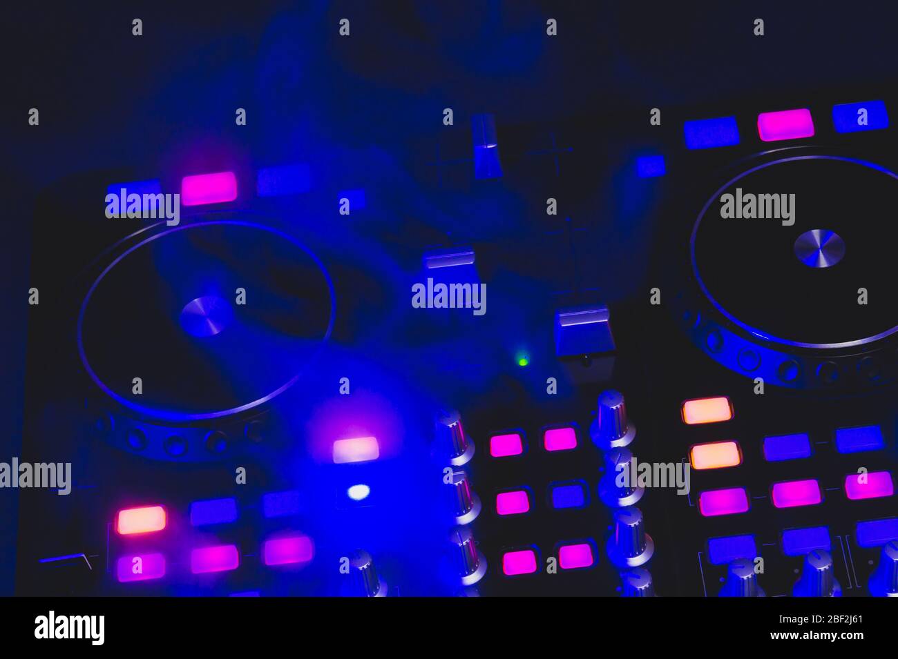 Dj sound mixer controller with knobs and sliders close up. audio mixing ...