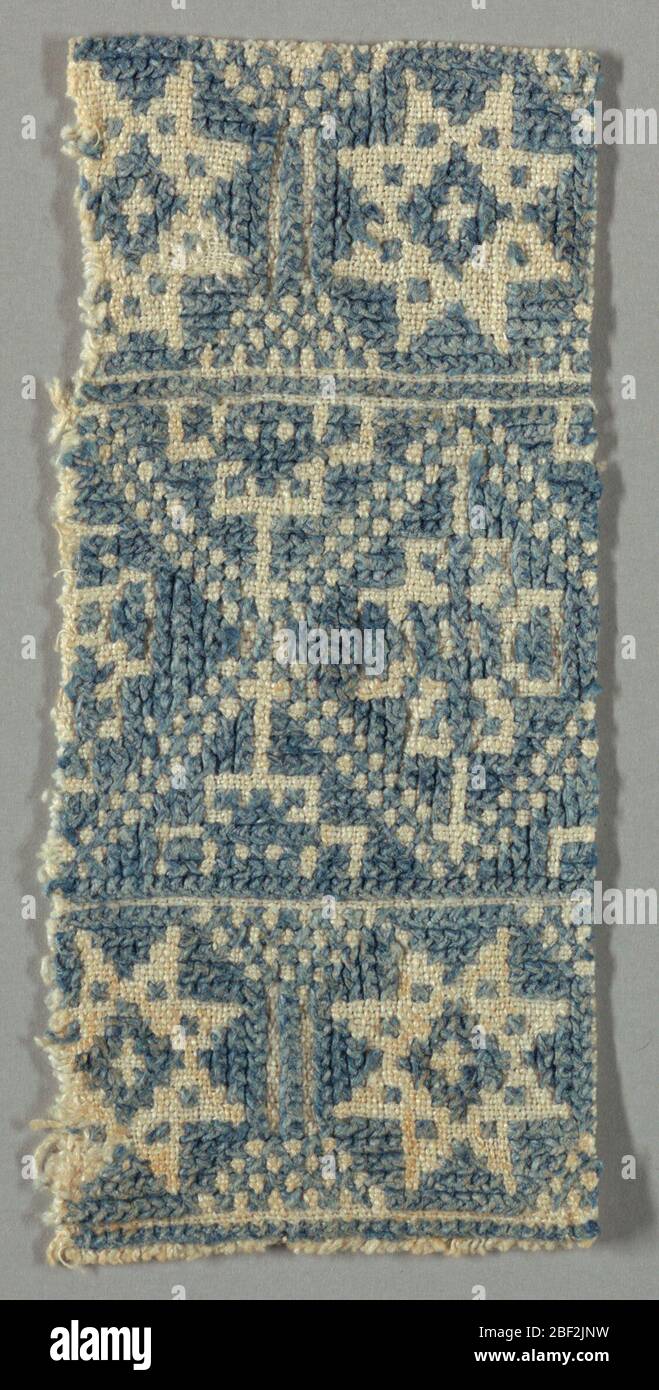 Textile. Design of lozenges and eight-pointed stars worked in blue ...