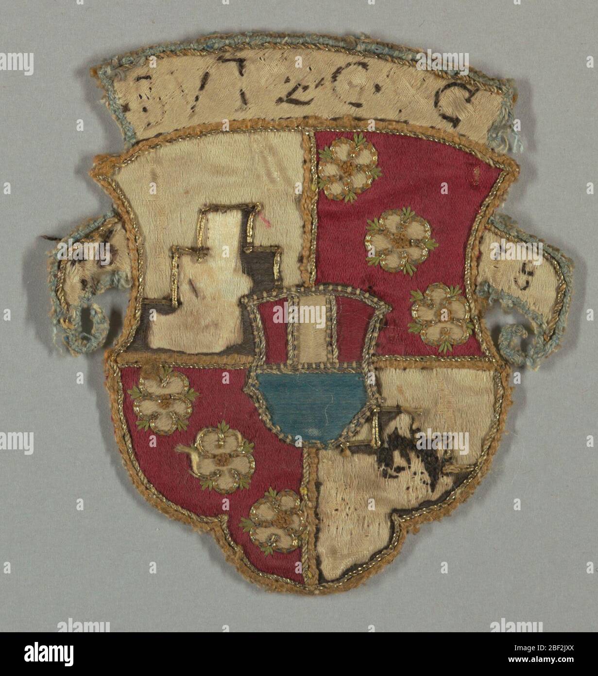 Badge. Shield divided into quarters alternately white satin with black ...