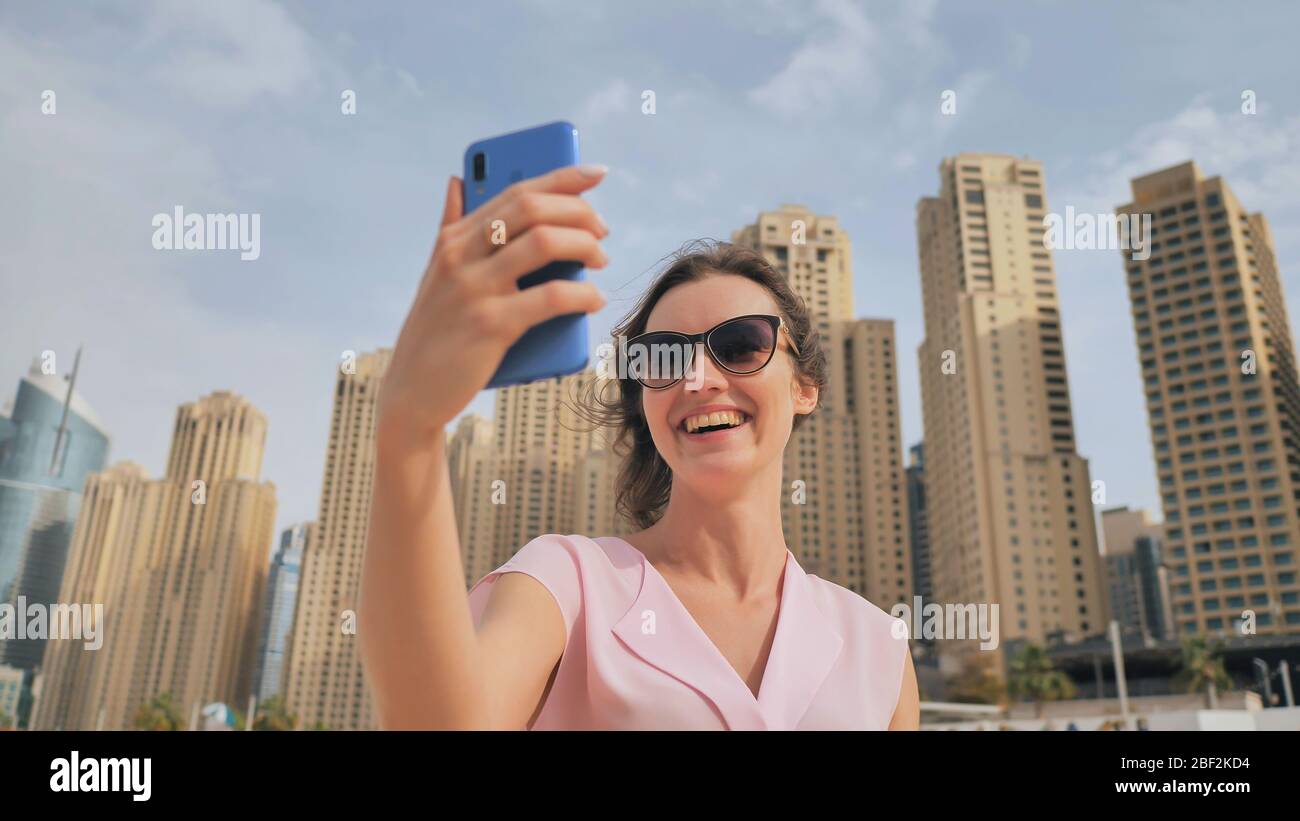 The girl is broadcasting live using a phone from Dubai Stock Photo - Alamy