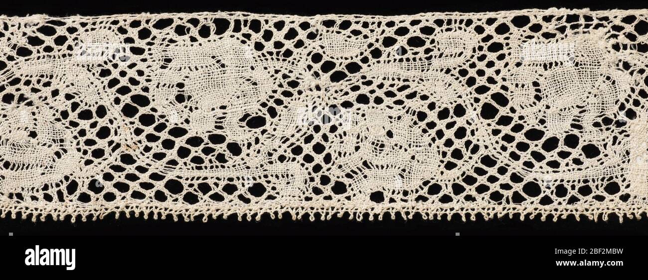 Band. Loosely worked design of a scrolling vine with large flower ...