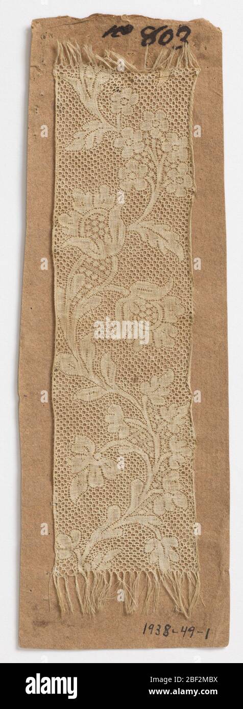 Sample. Design of flowers and leaves on curving stem. Lace is attached ...