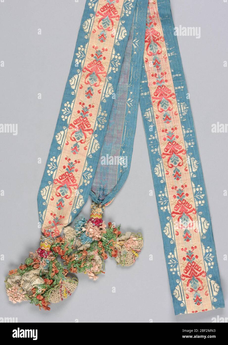 Sash. Sash of sky-blue ribbon patterned with a broad central band with ...