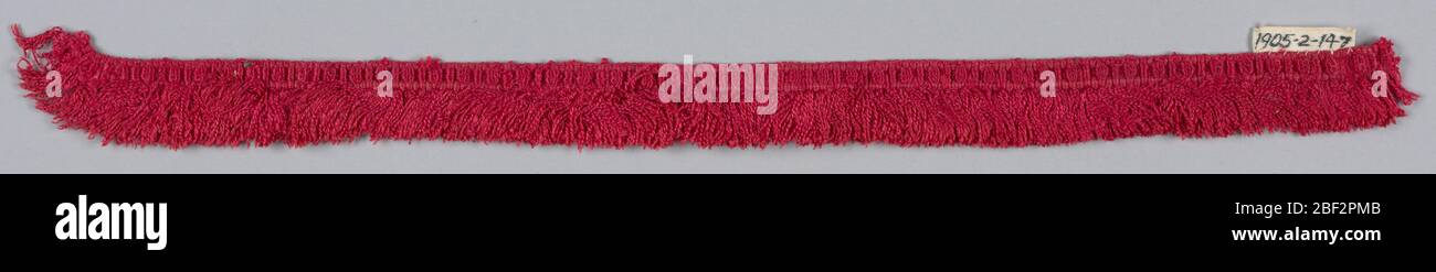 Fringe. Red fringe with an ornamental heading and red skirt threads ...