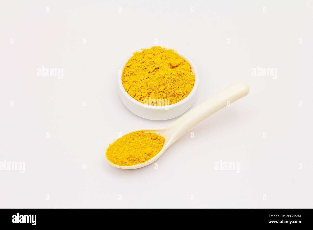 Dry turmeric powder isolated on white background. Traditional Indian ...