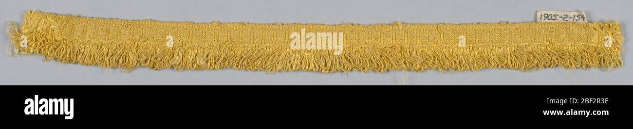 Fringe. Yellow fringe with a woven heading in a chain design. Skirt ...