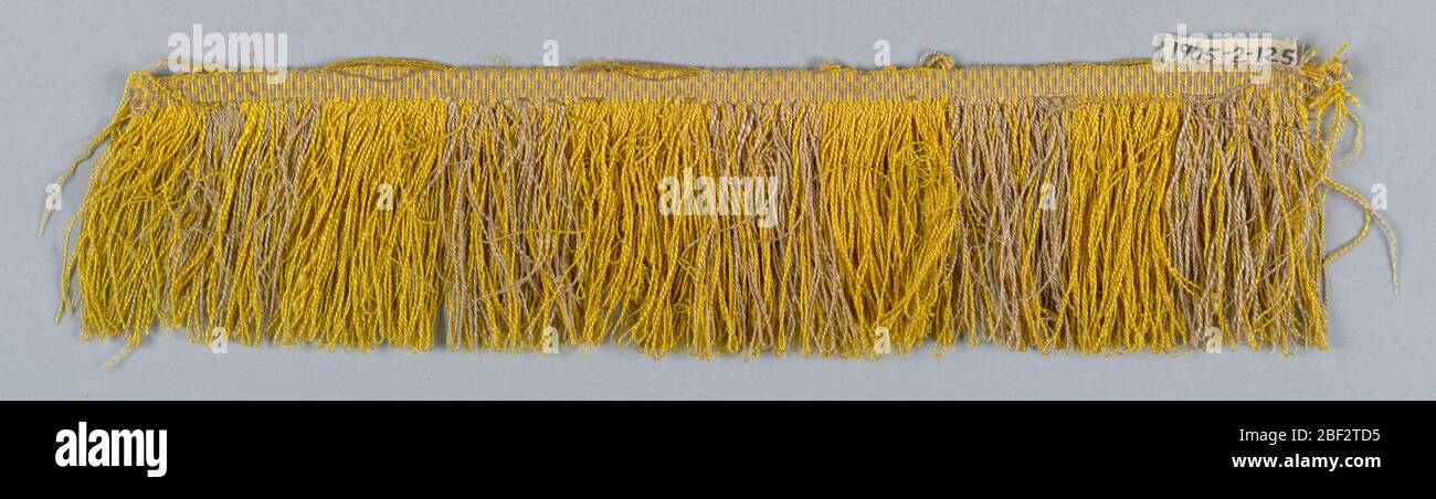 Fringe. Fringe with a yellow and tan plain-woven heading. Skirt threads ...