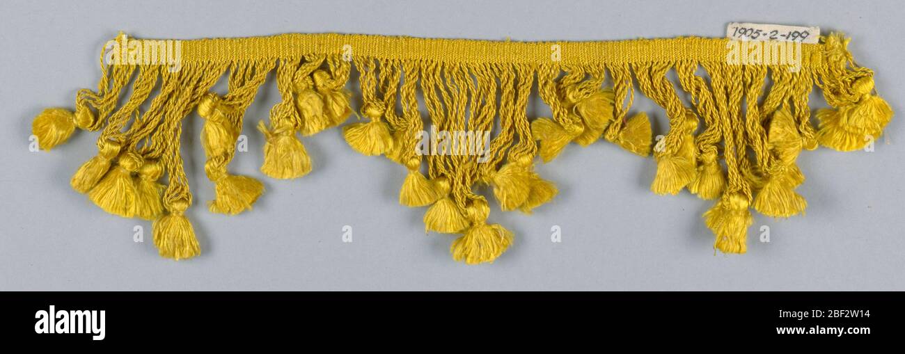 Fringe. Yellow fringe with a heading and looped skirt threads forming a ...