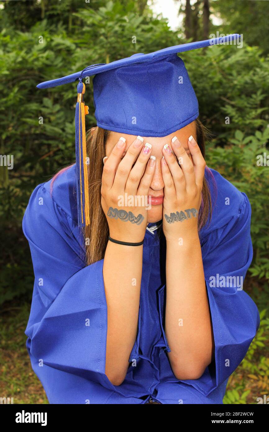 Young female soon-to-be graduate displaying uncertainty about future by ...