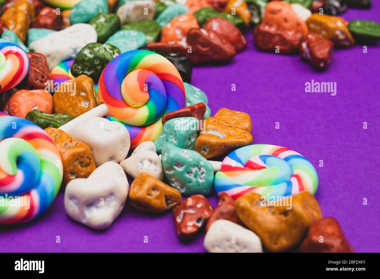 Lollipops and candy pebbles. sweets in the form of colored stones ...