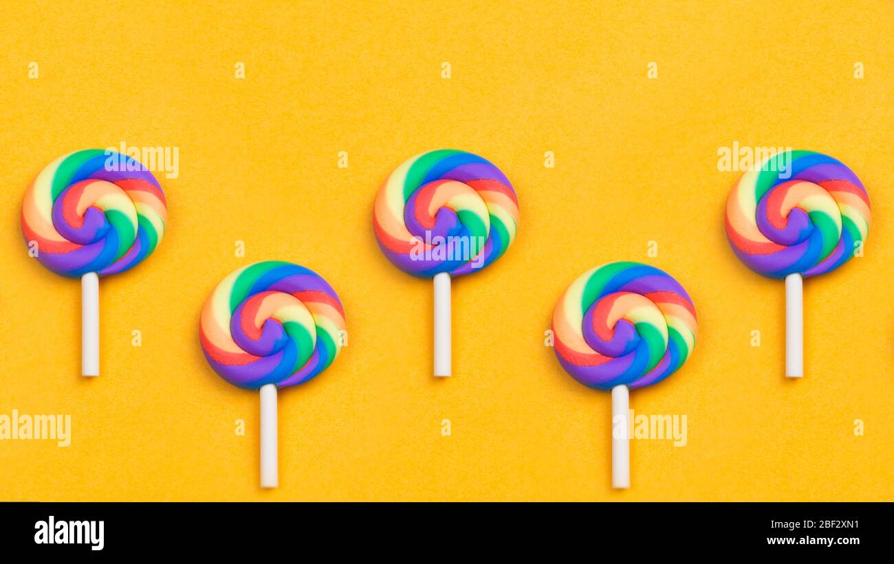 Lollipops are in a row. spiral candy pattern. lots of sweets on a ...