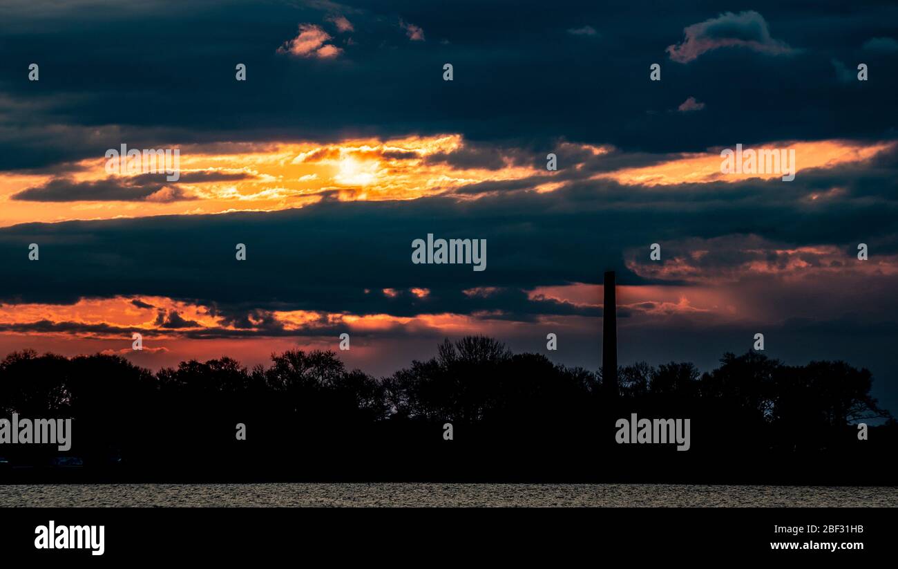 Big orange Sun is rising behind heavy clouds Stock Photo - Alamy