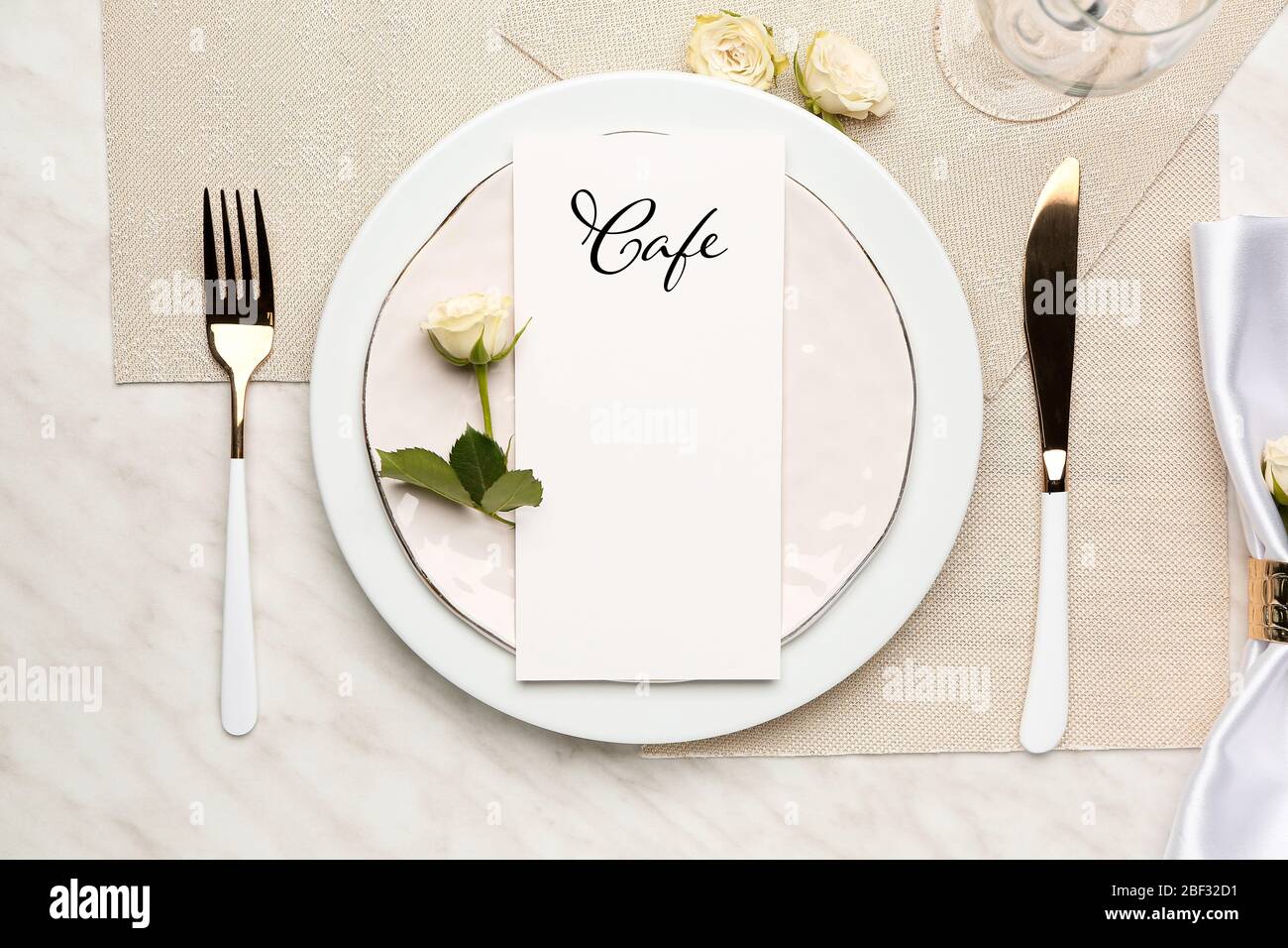 Beautiful table setting with menu on light background Stock Photo - Alamy