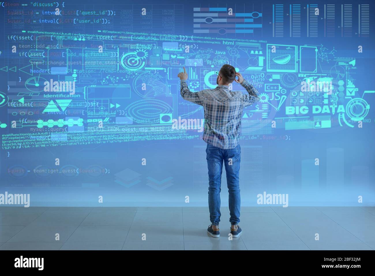 Male programmer using virtual screen, back view Stock Photo - Alamy