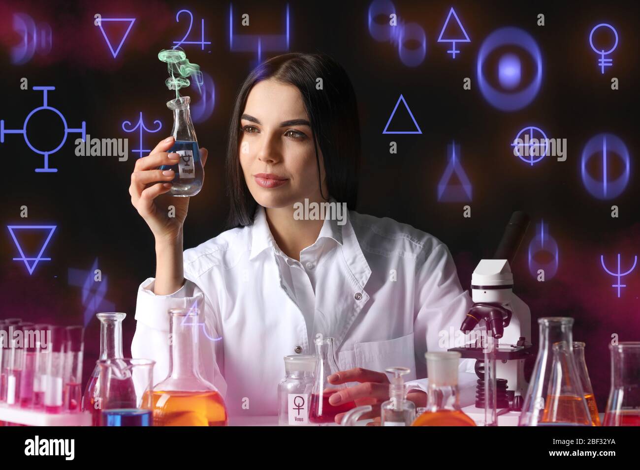 Female alchemist with elixir in laboratory Stock Photo - Alamy