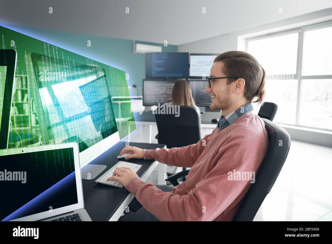 Male programmer working in office Stock Photo - Alamy