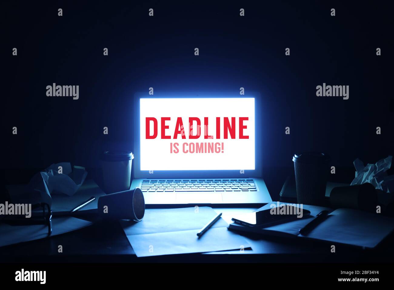 Laptop with text DEADLINE IS COMING on screen at messy workplace Stock ...