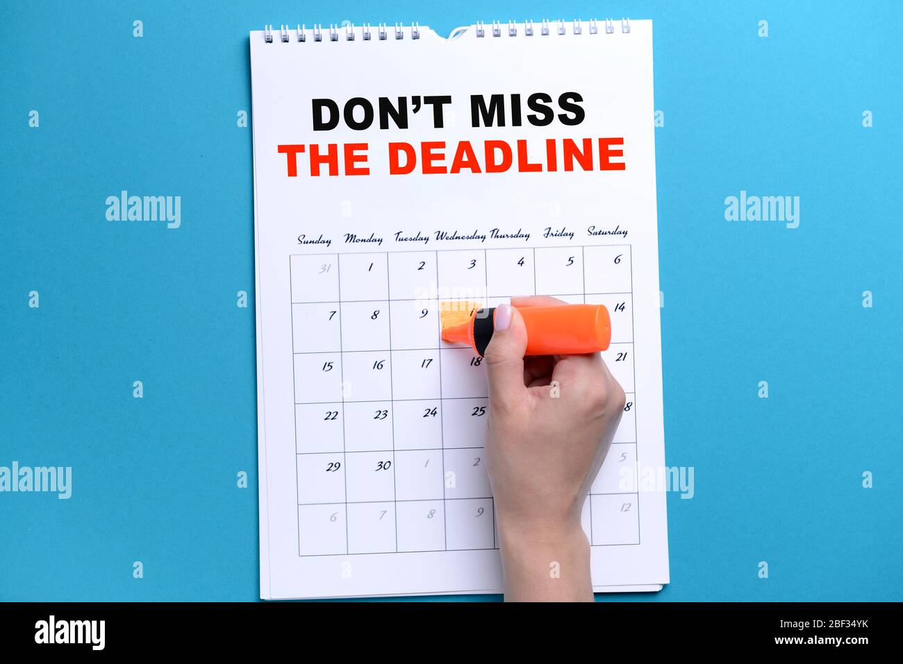 Woman marking date in calendar with text DON'T MISS THE DEADLINE on ...