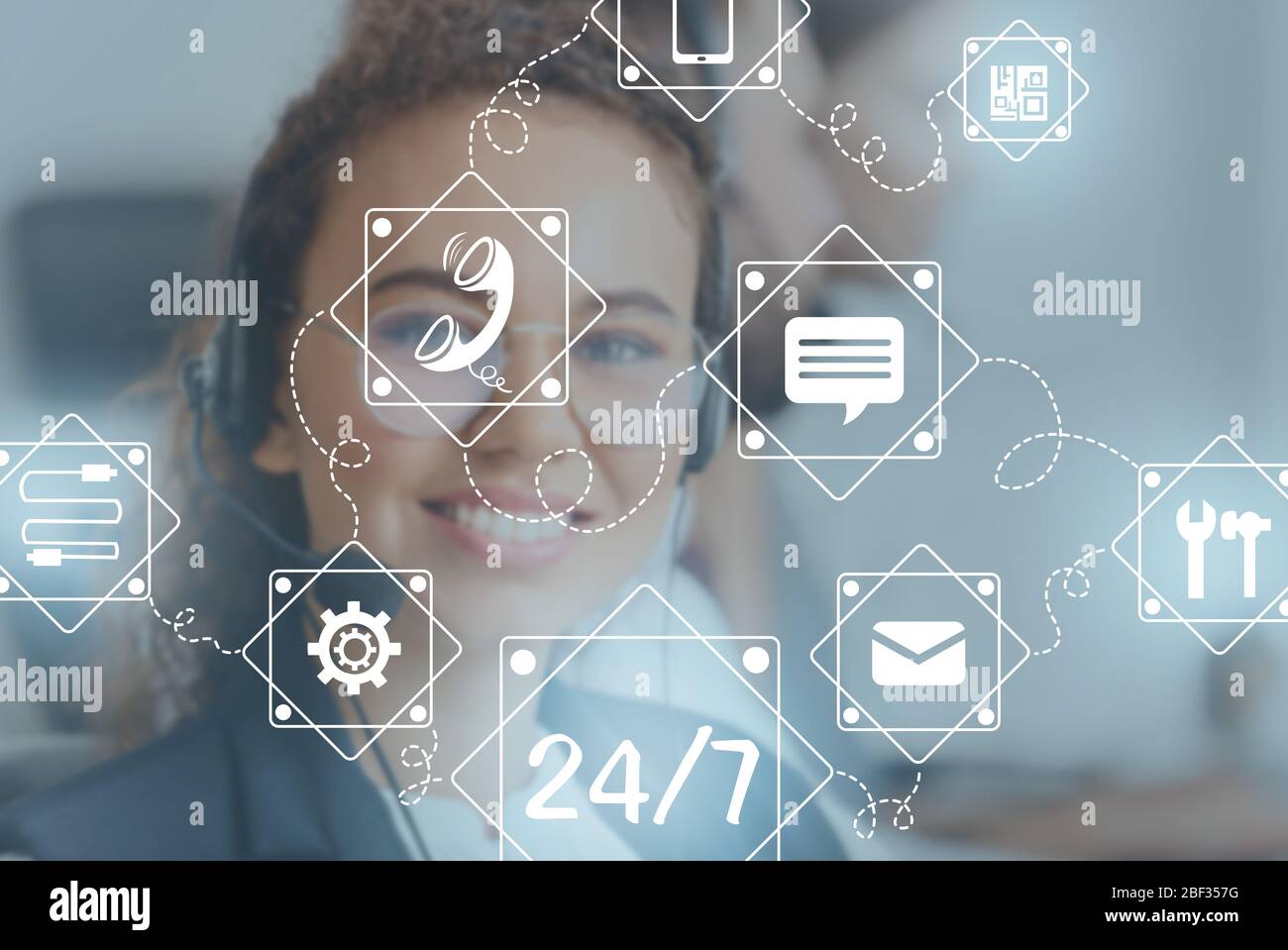 Technical support agent and digital icons in office Stock Photo - Alamy