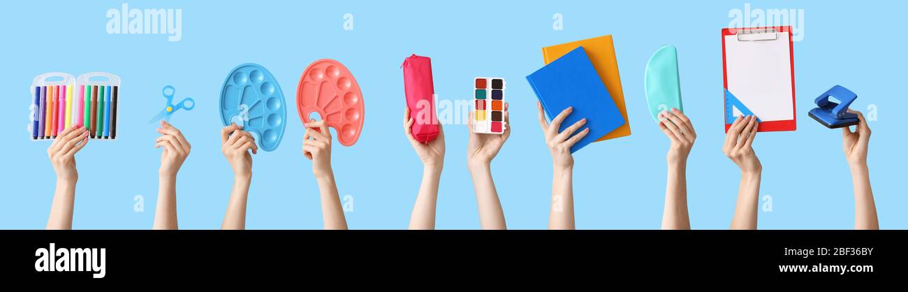 Many hands with school supplies on color background Stock Photo - Alamy