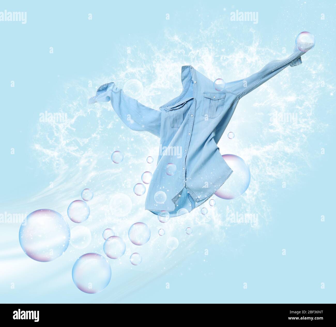 Clean shirt with soap bubbles and water splash on color background ...