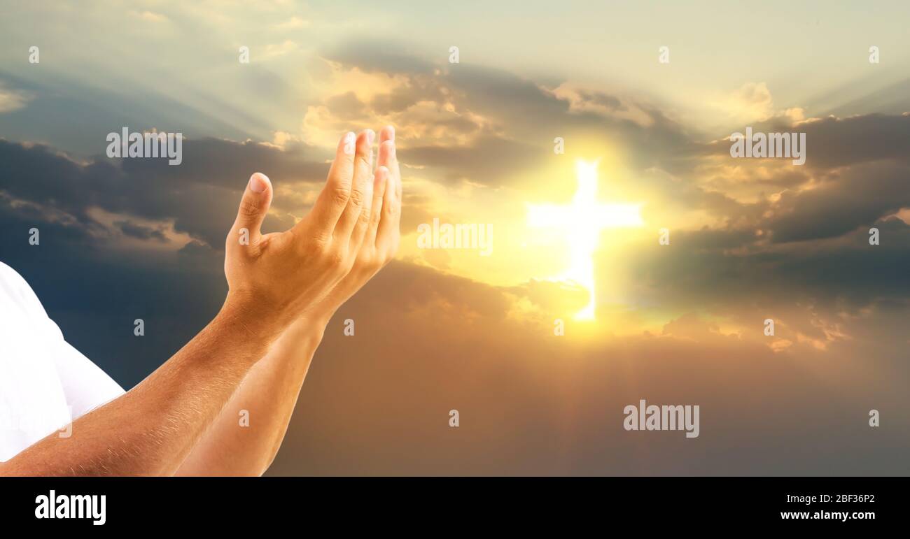Religious young man praying outdoors Stock Photo - Alamy