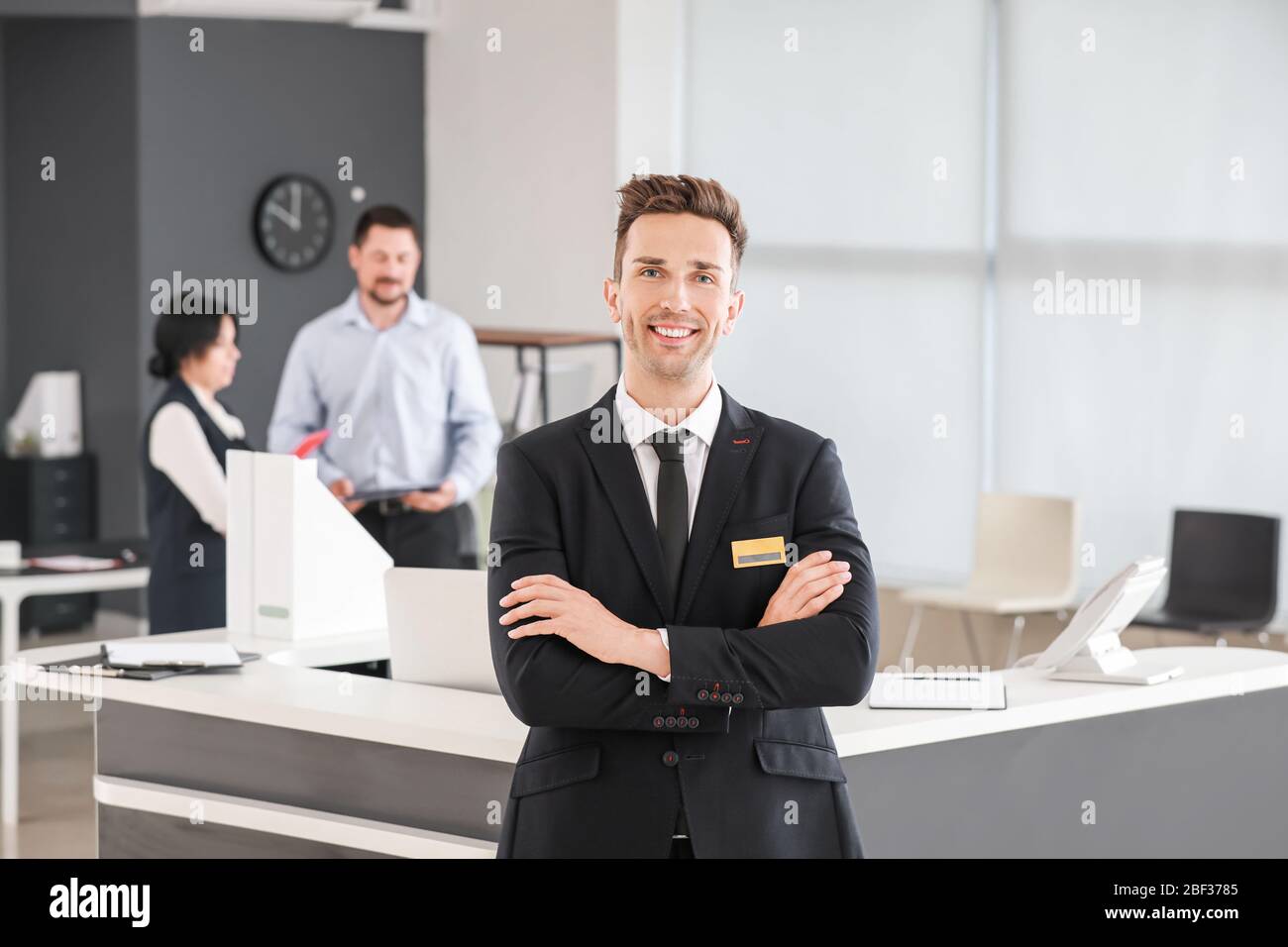 Portrait of male receptionist in office Stock Photo - Alamy