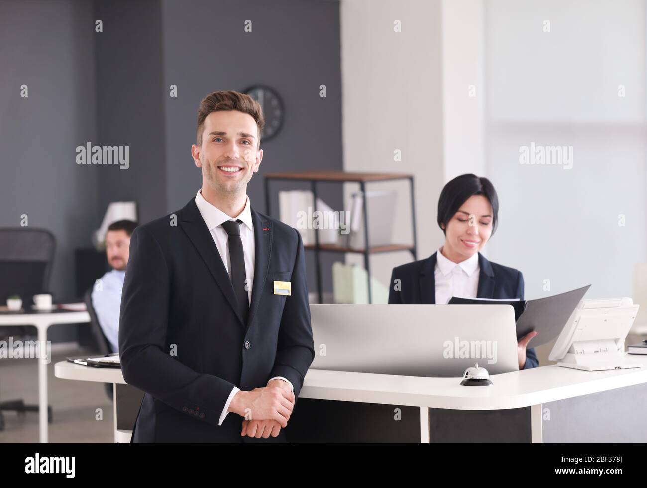 Portrait of male receptionist in office Stock Photo - Alamy