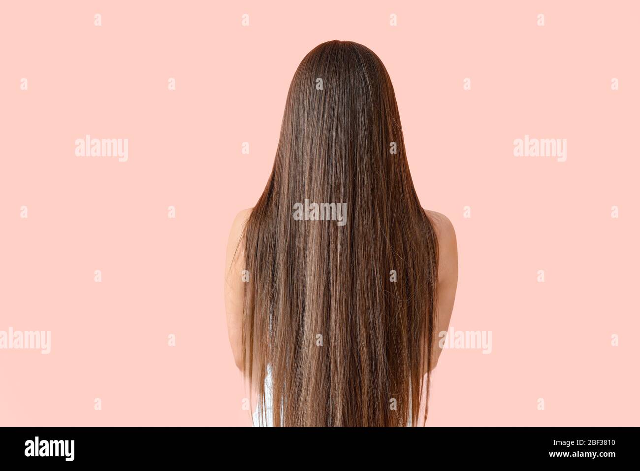 Beautiful woman with healthy long hair on color background, back view ...