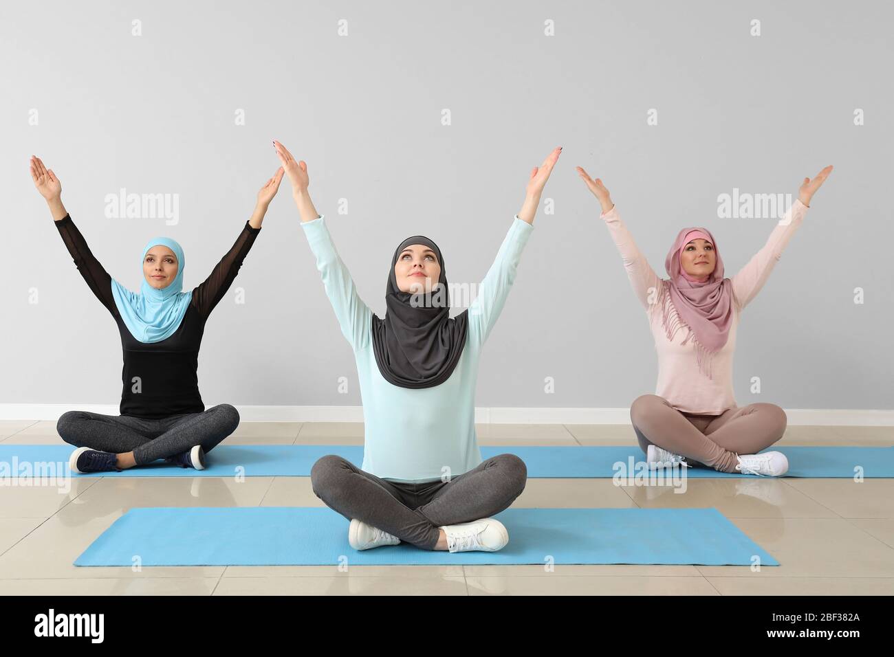 Sporty Muslim women practicing yoga in gym Stock Photo - Alamy