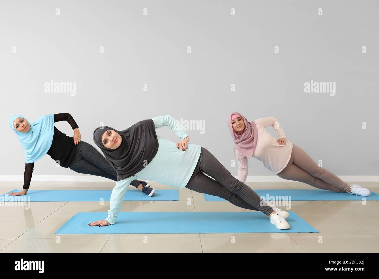 Sporty Muslim women practicing yoga in gym Stock Photo - Alamy