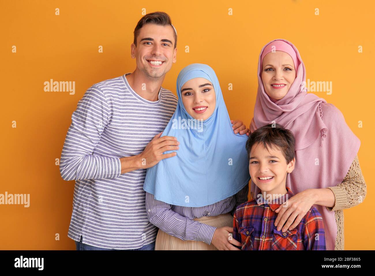 Portrait of Muslim family on color background Stock Photo - Alamy