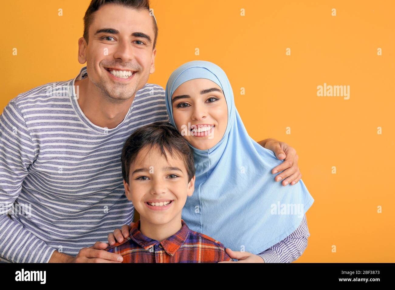 Portrait of Muslim family on color background Stock Photo - Alamy