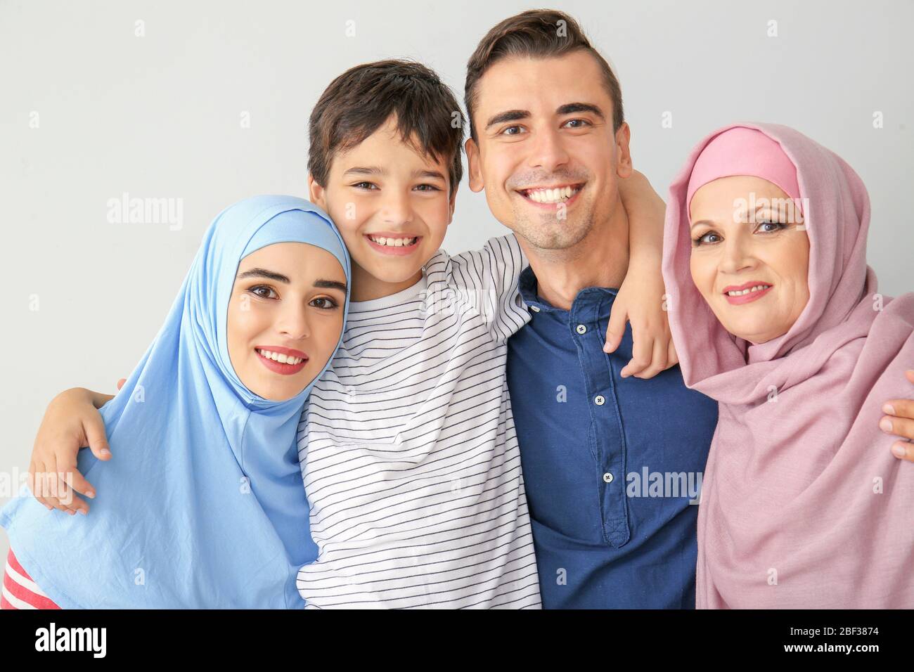 Portrait of Muslim family on light background Stock Photo - Alamy