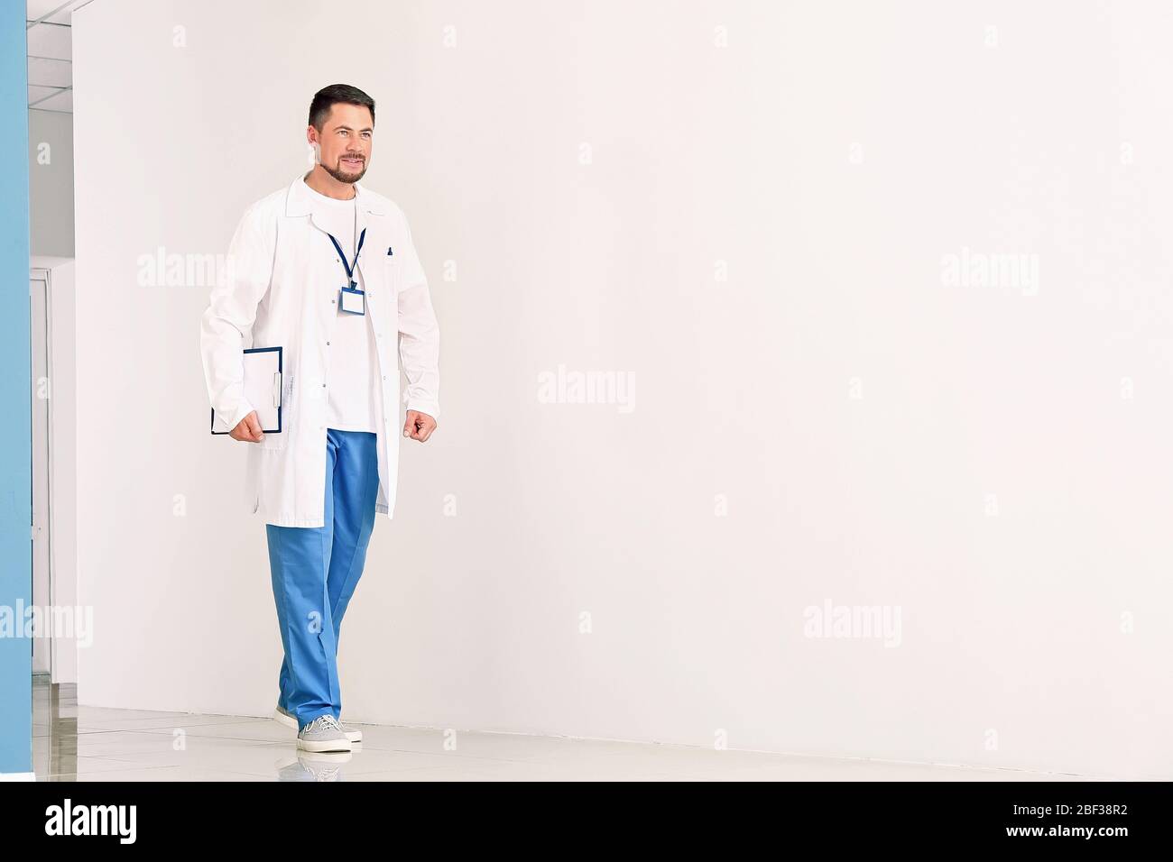 Male doctor in hall of clinic Stock Photo - Alamy