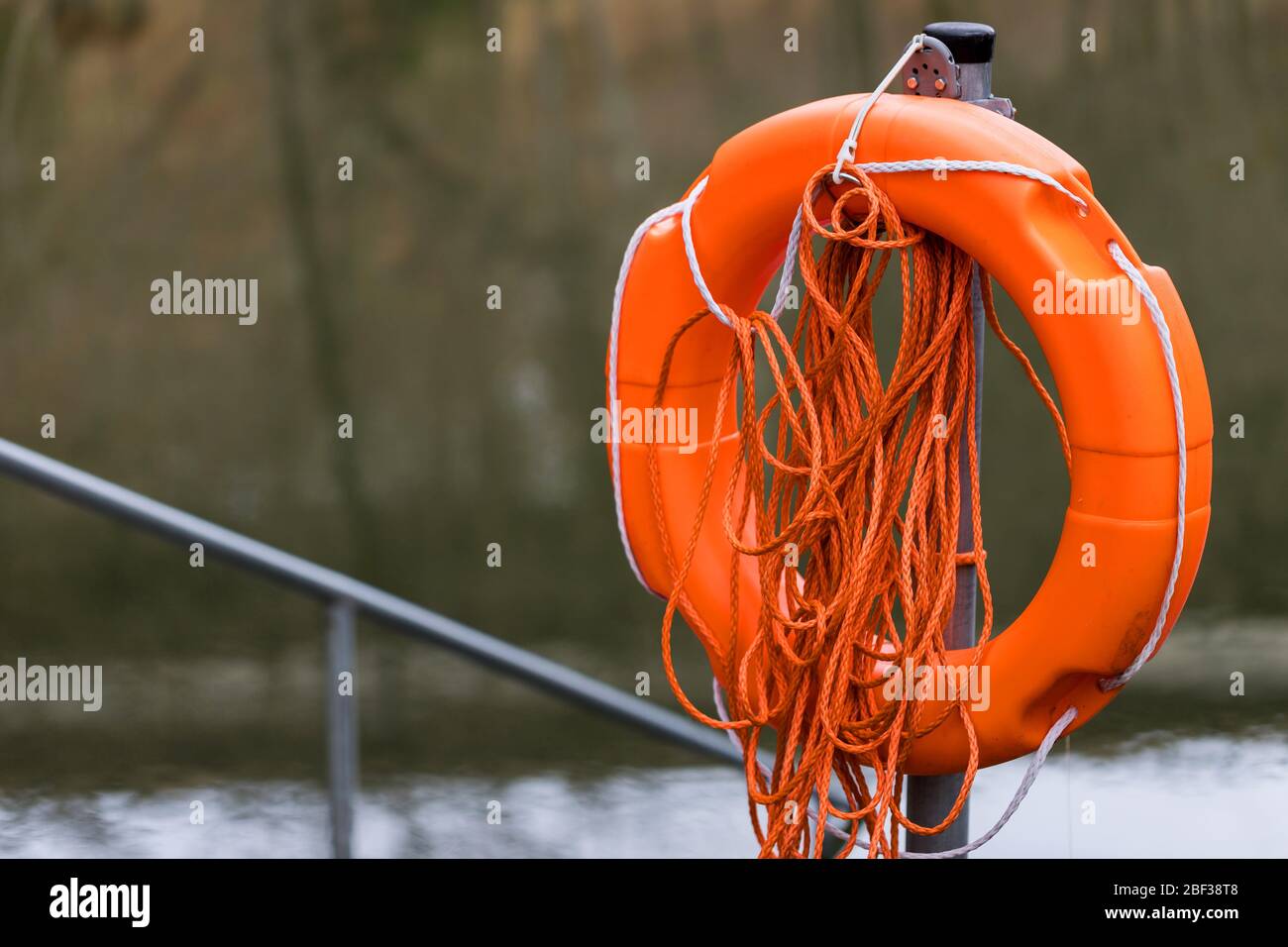 orange lifebuoy on a lake Stock Photo - Alamy