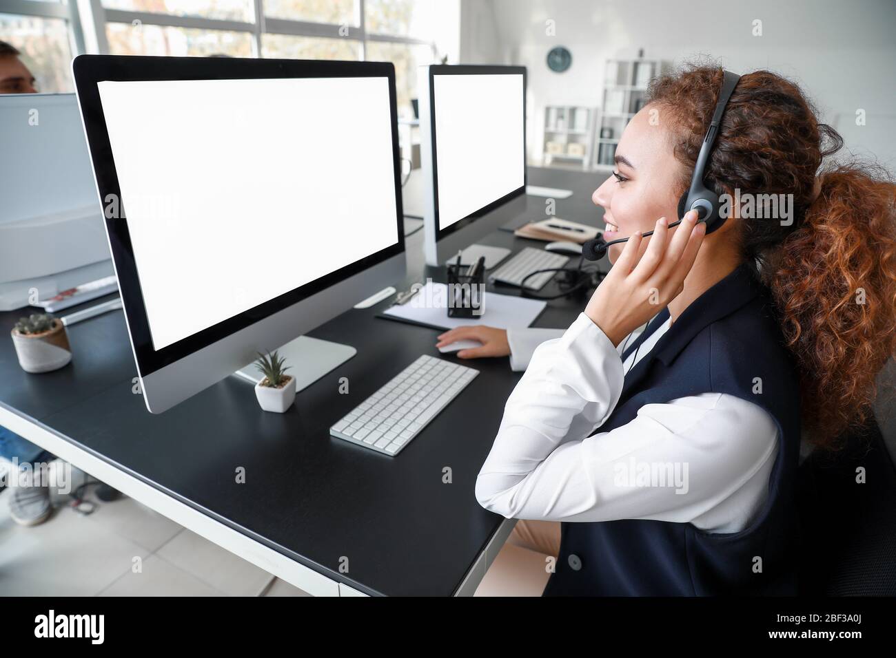 Technical support agent working in office Stock Photo - Alamy
