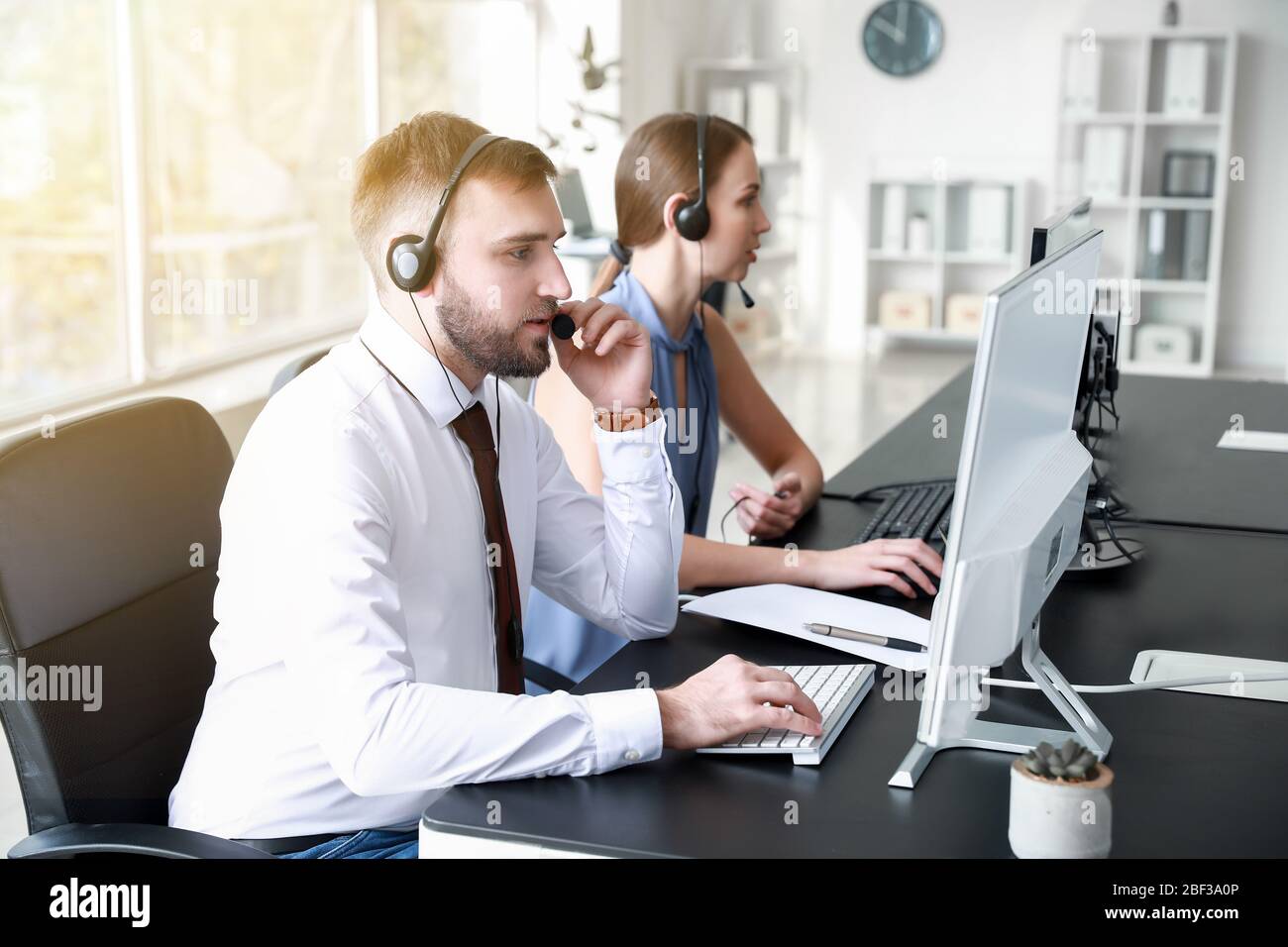 Technical support agents working in office Stock Photo - Alamy