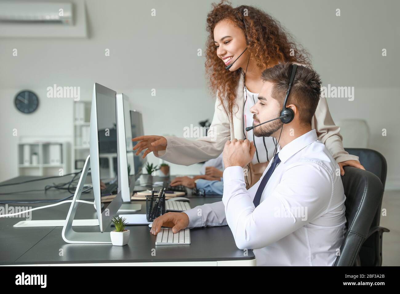 Technical support agents working in office Stock Photo - Alamy