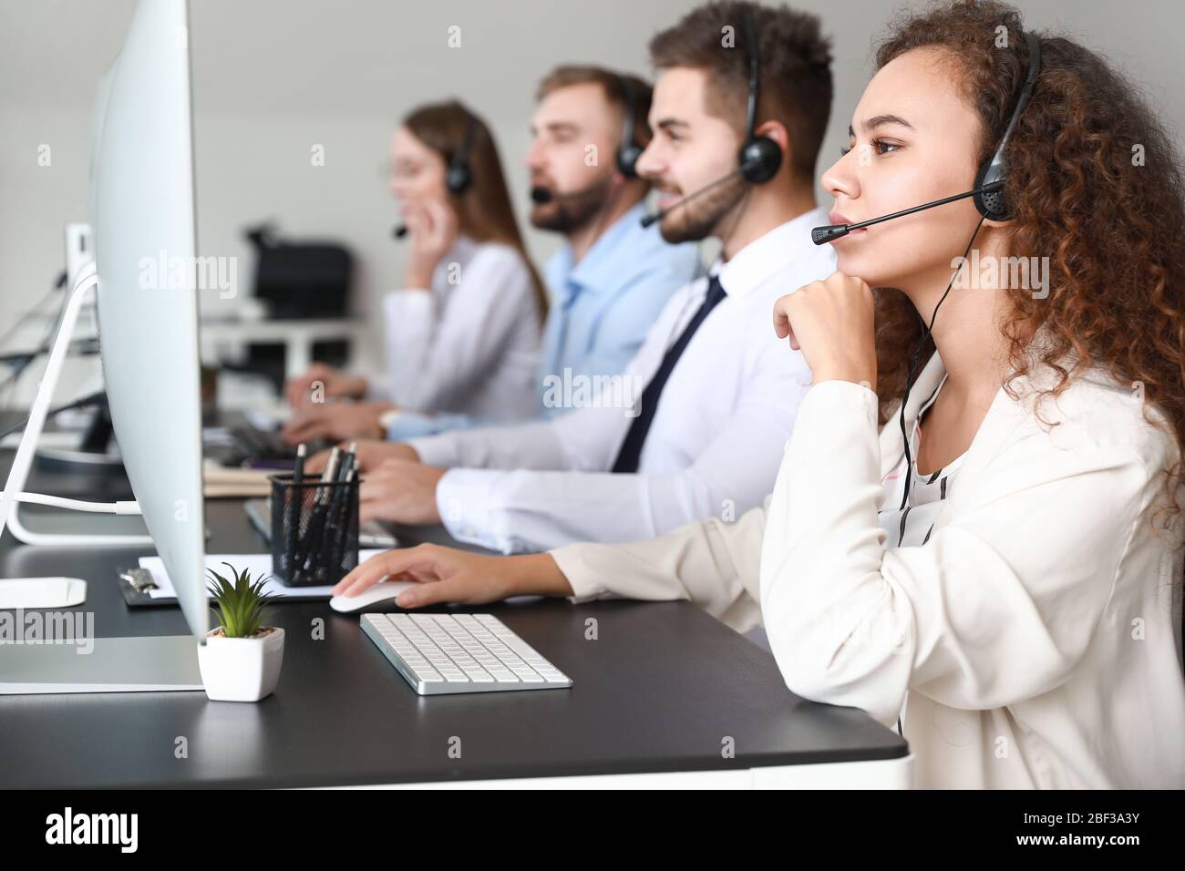 Technical support agents working in office Stock Photo - Alamy