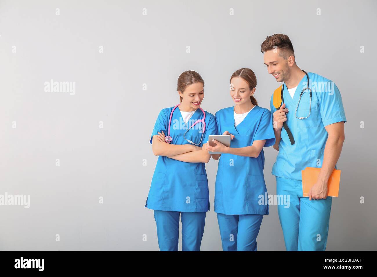 Group of medical students on light background Stock Photo - Alamy