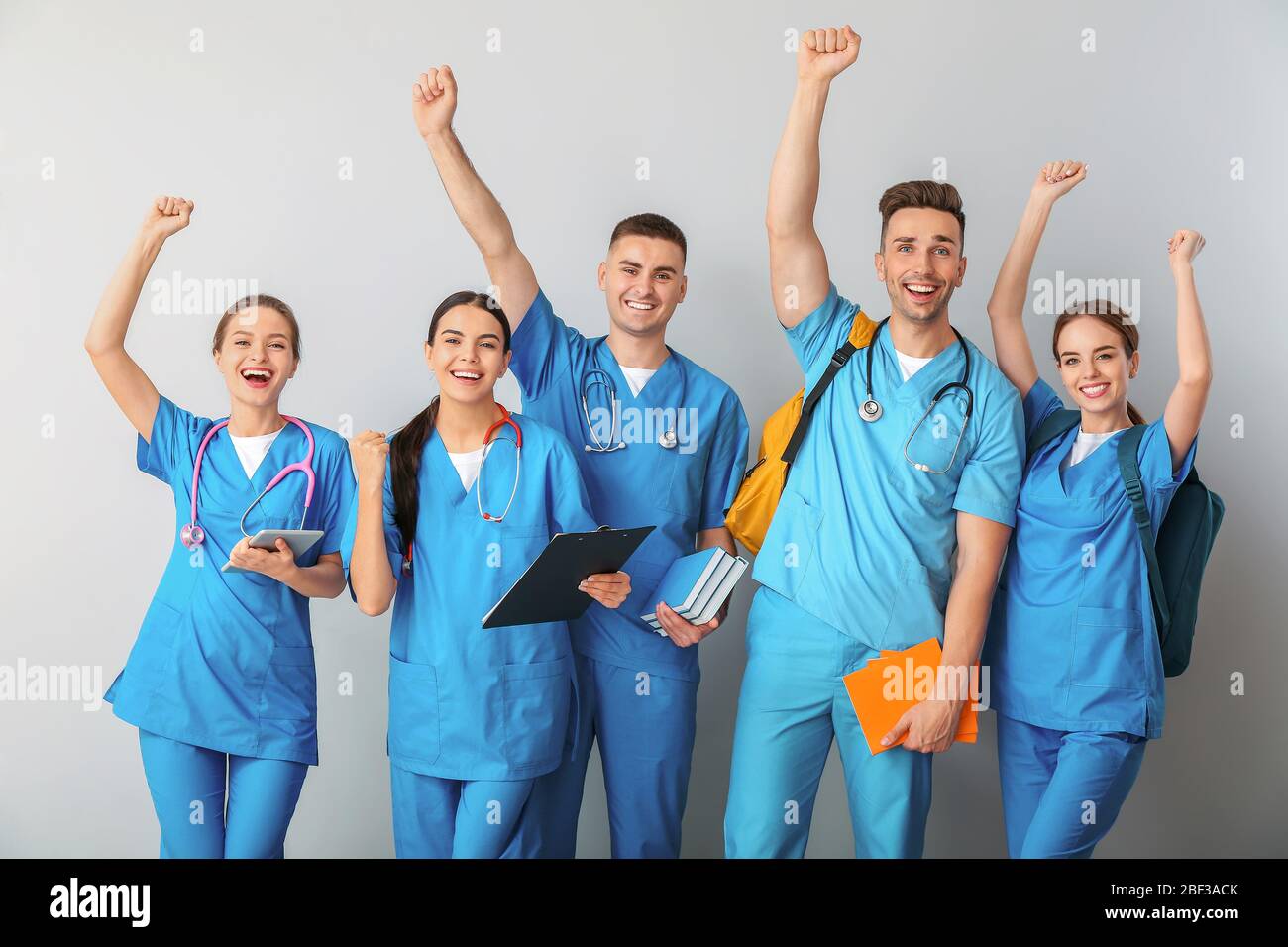 Group of happy medical students on light background Stock Photo - Alamy