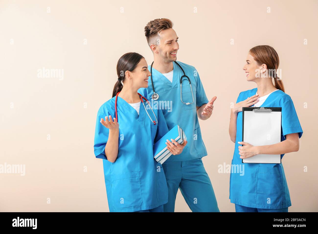 Group of medical students on light background Stock Photo - Alamy