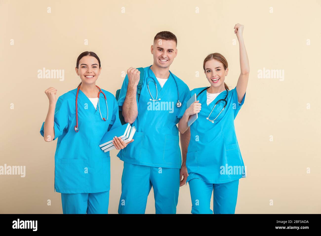 Group of happy medical students on light background Stock Photo - Alamy