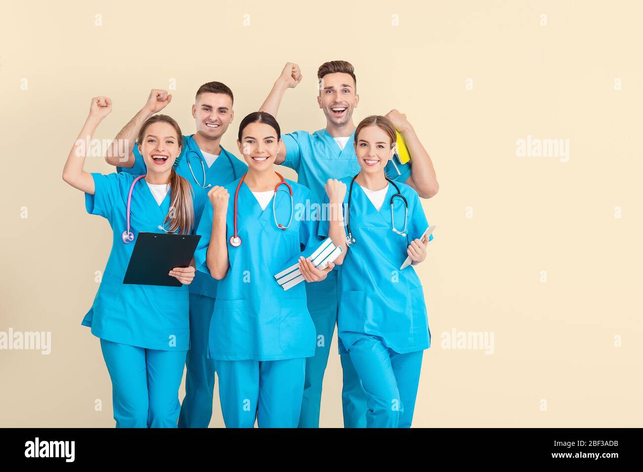 Group of happy medical students on light background Stock Photo - Alamy