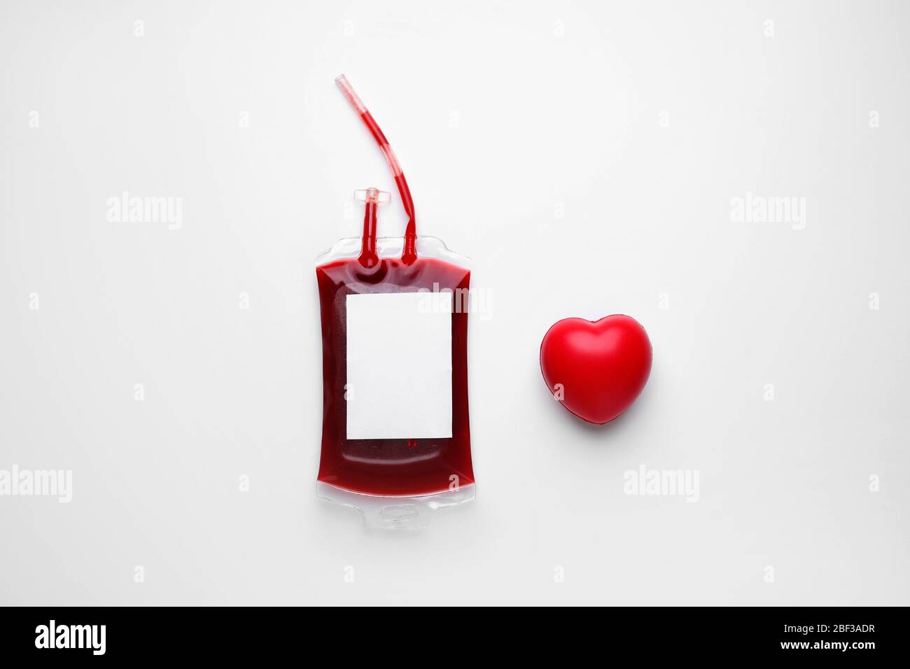 Blood pack for transfusion and heart on white background Stock Photo ...
