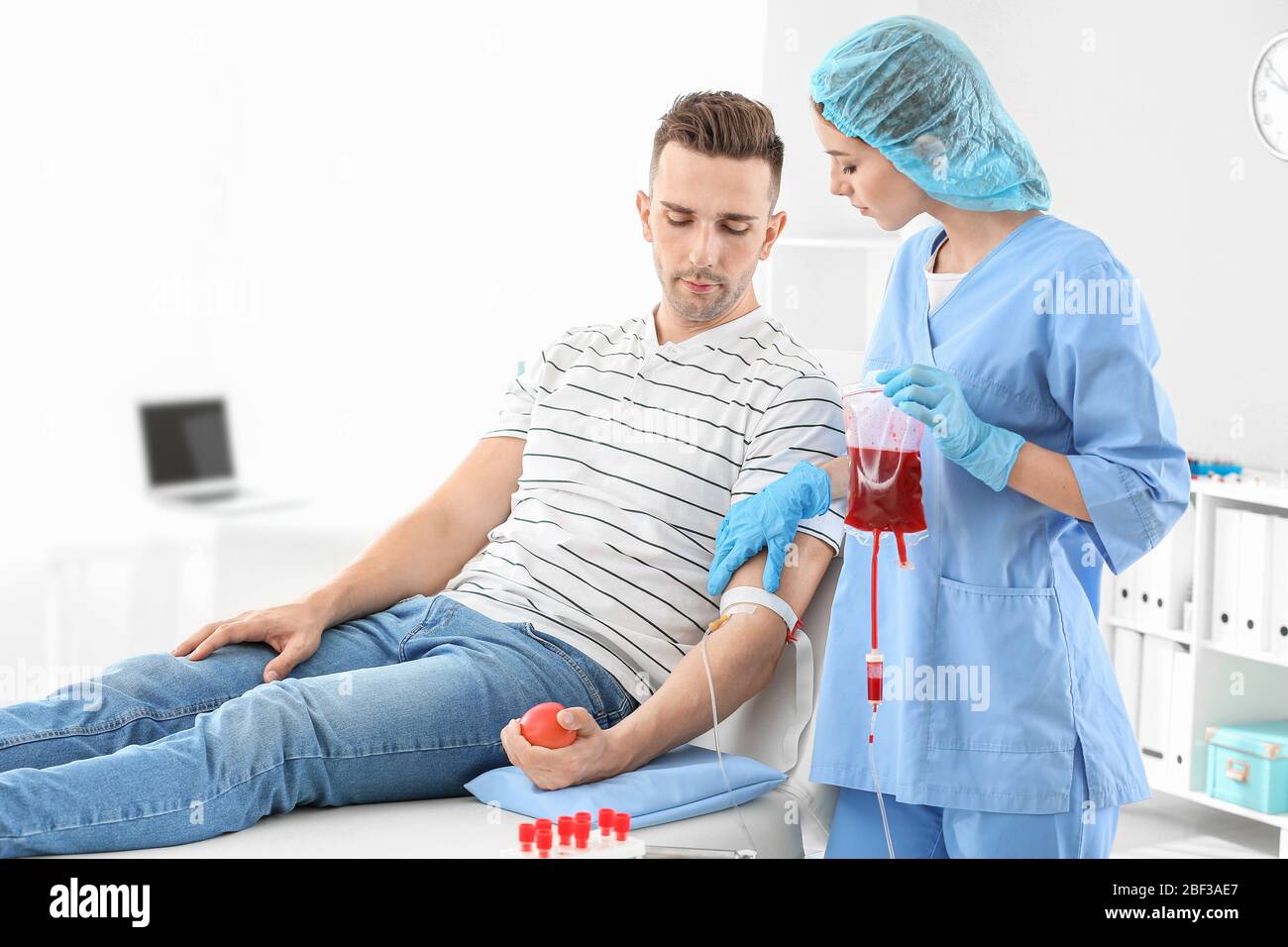 Man donating blood in hospital Stock Photo - Alamy